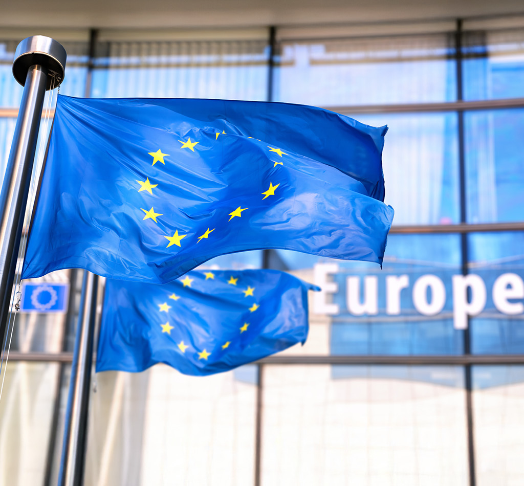 European Union flags waving in front of European Commission.