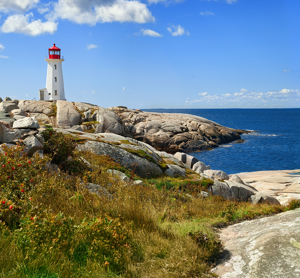 Nova Scotia's iconic Peggys Cove Lighthouse on a sunny day.
